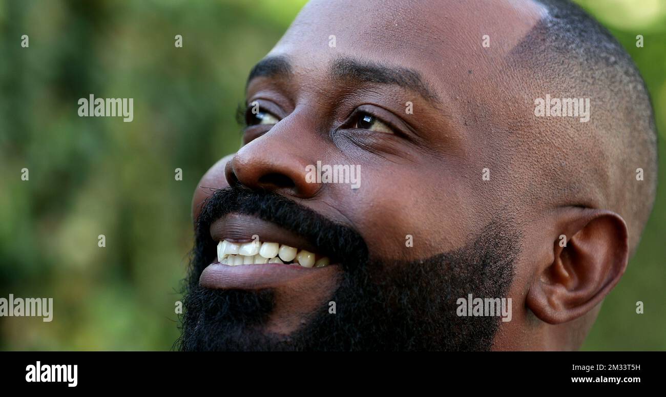 Positive African breathing fresh air outside, happy close-up face ...