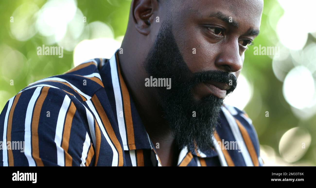 Pensive african man thinking sitting hi-res stock photography and ...