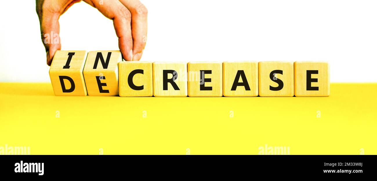 Increase or decrease symbol. Concept words Increase and Decrease on wooden cubes. Businessman ...