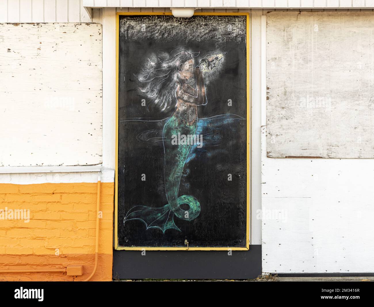 weathered and neglected chalk drawing of a mermaid at Sunset Beach ...