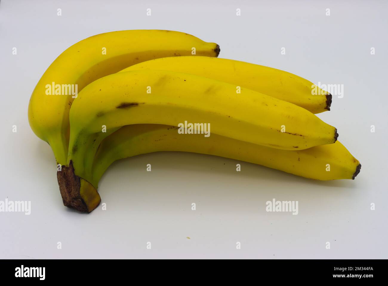 Bunch of ripped bananas on a white background Stock Photo - Alamy