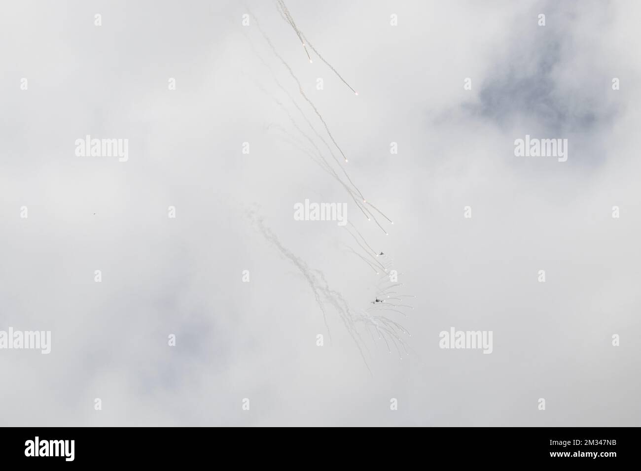 A combat jet throwing yellow flares over crow during air force ...