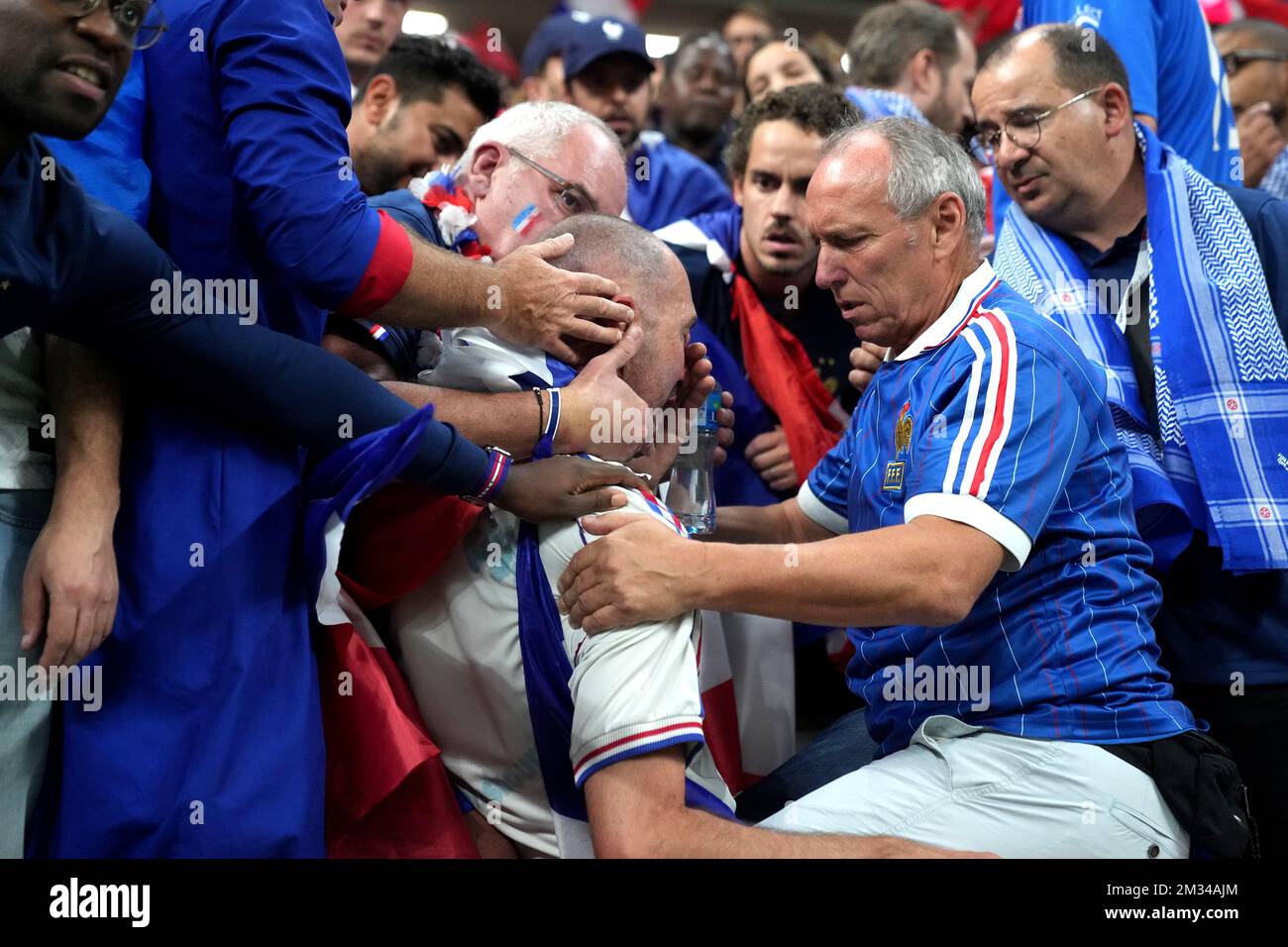 A France fan appears injured after being struck by a ball from France's ...