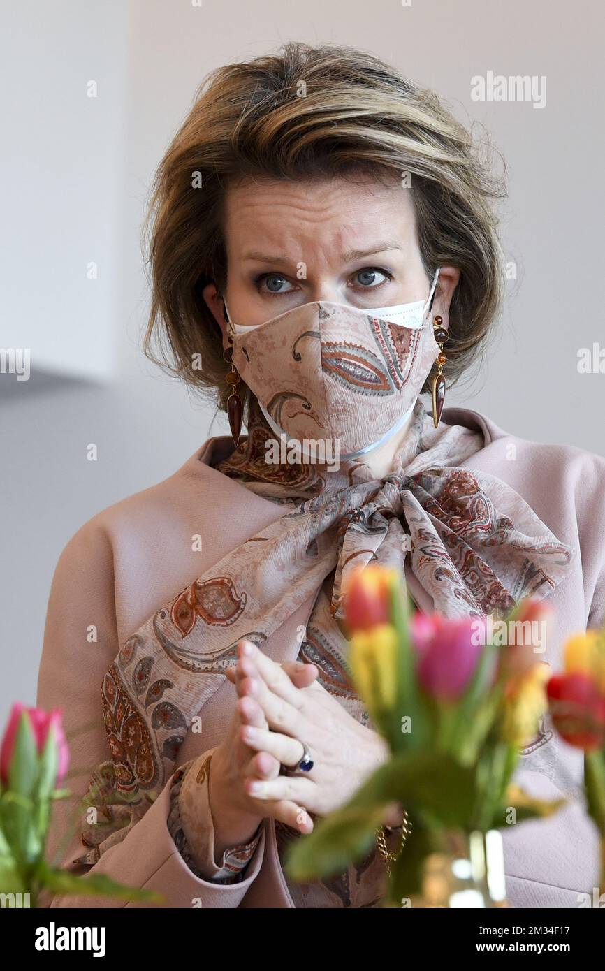 Queen Mathilde of Belgium wears a face mask during a royal visit to the ...