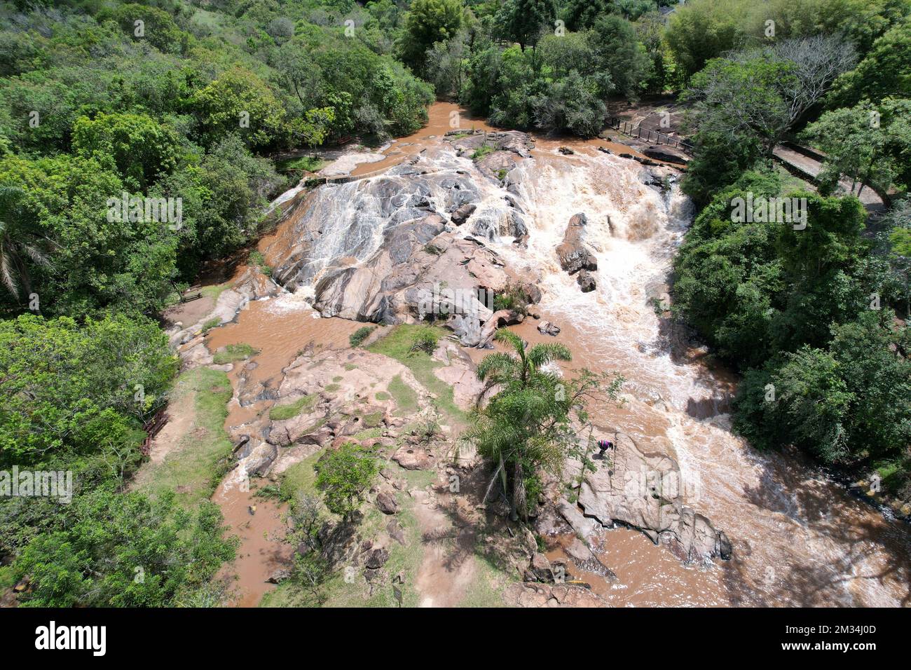 An aerial shot of a river surrounded by lush greenery in Cachoeira ...