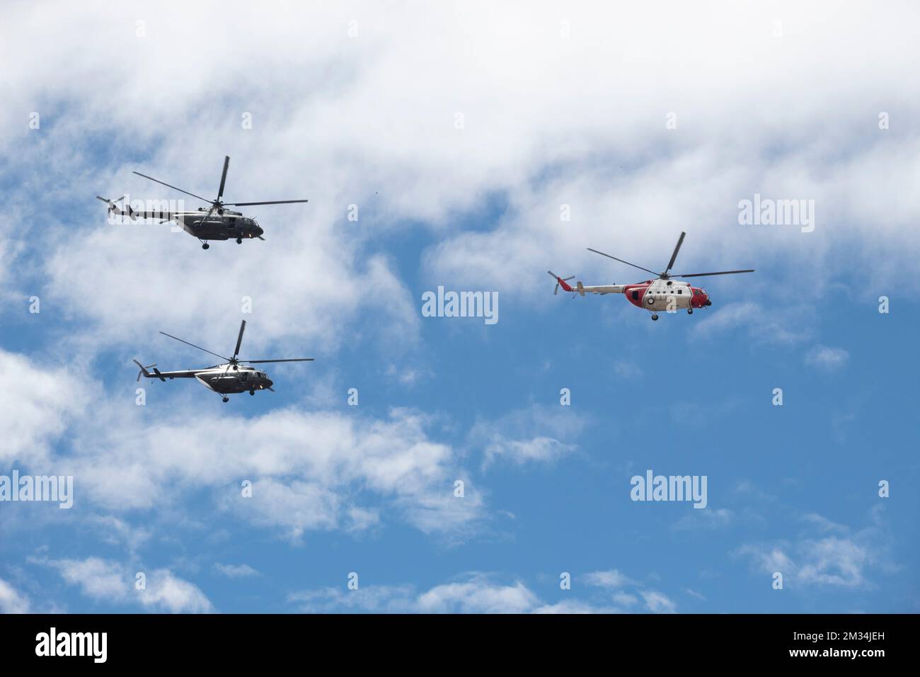 Three MI-17 army helicopters flying over crow during colombian ...