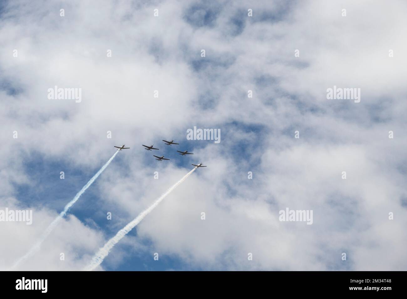 Super Tucano airplanes flying in V formation with blue cloudy sky at ...