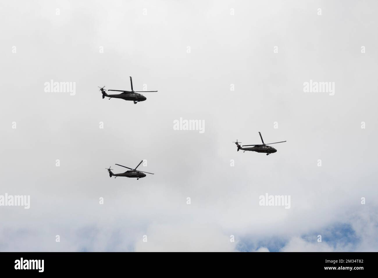 Three helicopters flying in formation hi-res stock photography and ...
