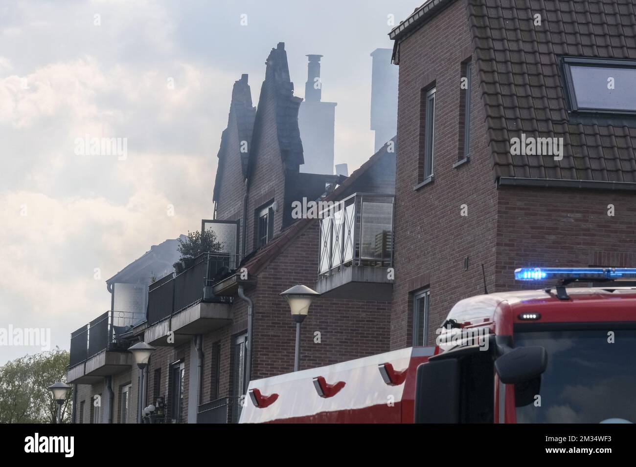 Firefighters pictured in action at a fire in an apartment building ...