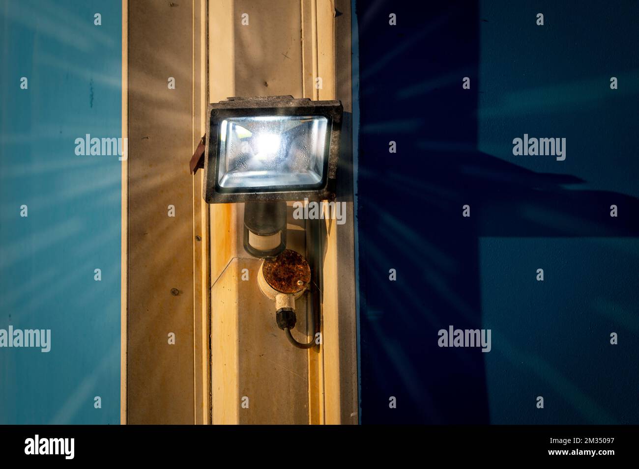 Illuminated security light on the side of a building Stock Photo - Alamy