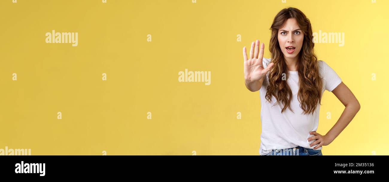 Stop right there fashion police. Serious-looking confident young curly ...