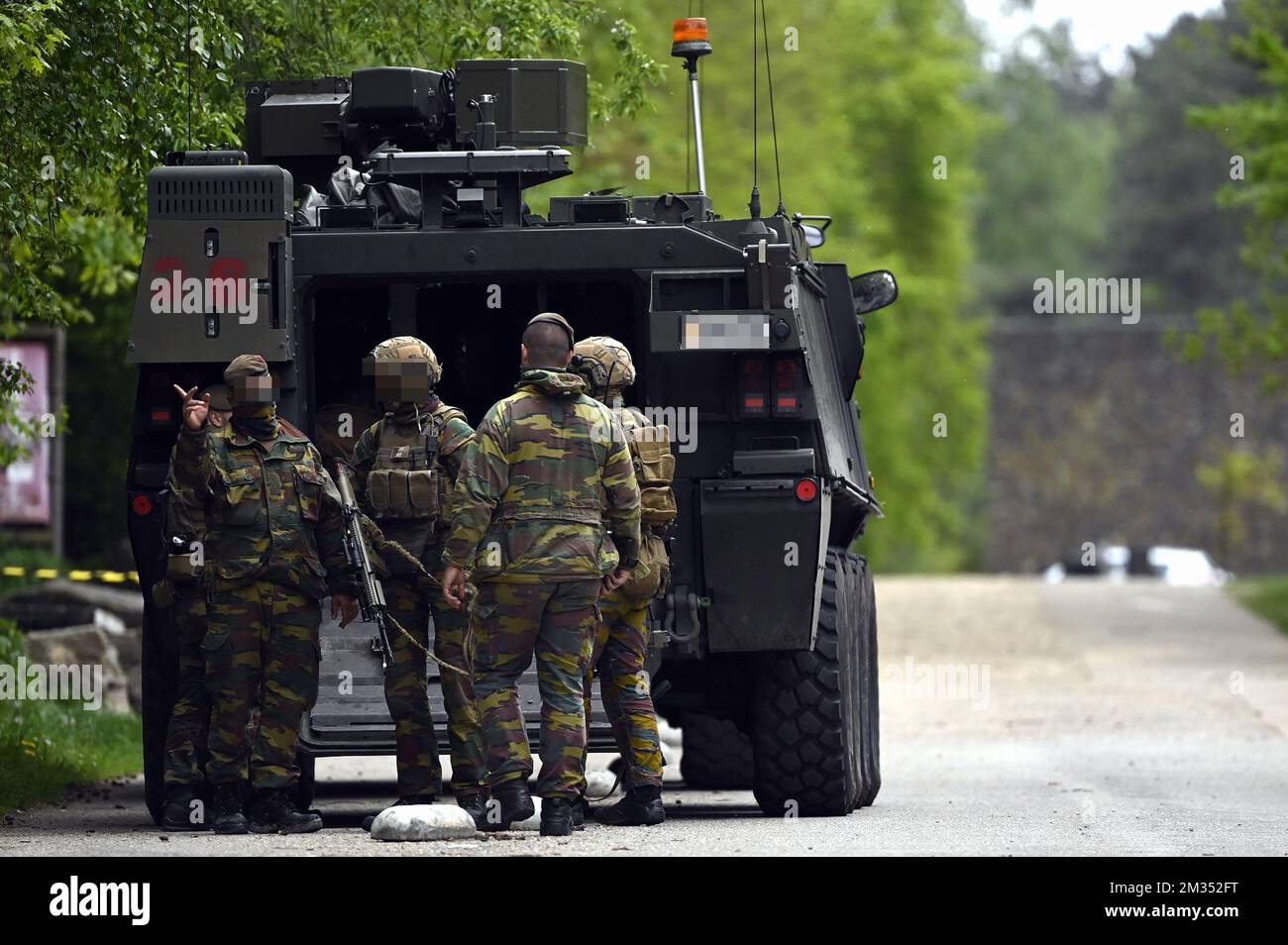 Illustration picture shows soldiers standing near an armoured vehicle ...