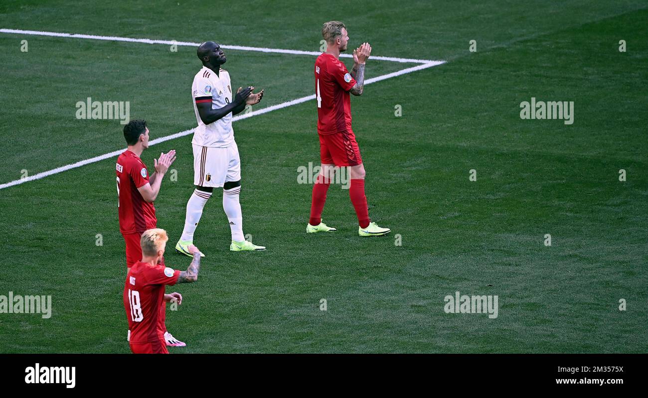 Belgium's Romelu Lukaku and Danish Simon Kjaer react during a moment to ...