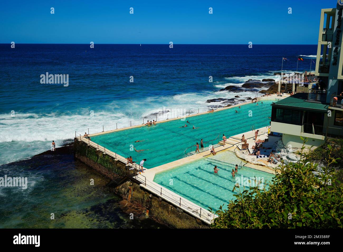 A beautiful shot of people in a pool on the Bondi Beach pool with a ...