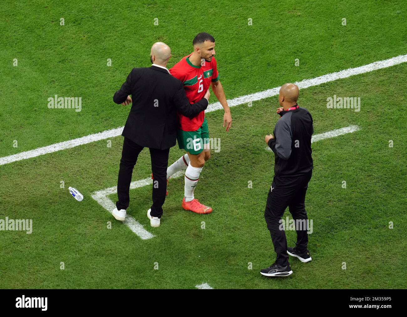 Morocco's Romain Saiss with manager Walid Regragui after going off ...