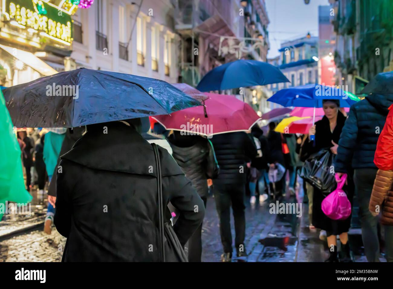 Naples, Italy - December 10, 2022: On a rainy day people stroll in via ...