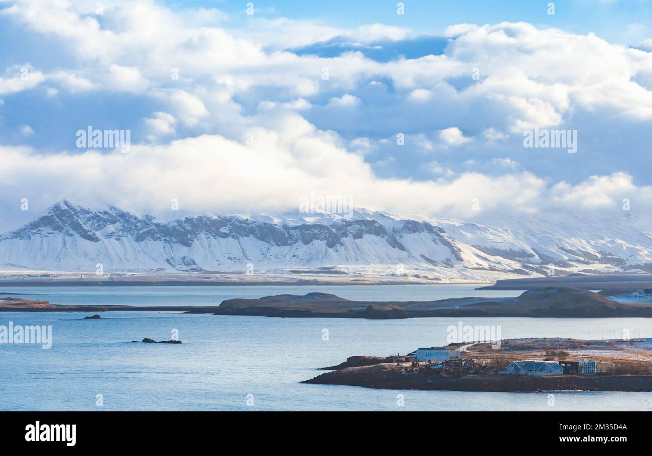 Landscape photo of Reykjavik bay with snowy coastal mountains under ...