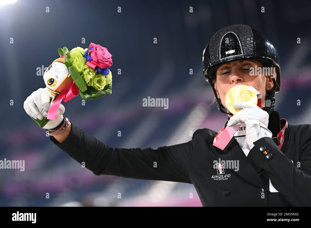 Belgian jockey Michele George, winner of the gold medal celebrates ...
