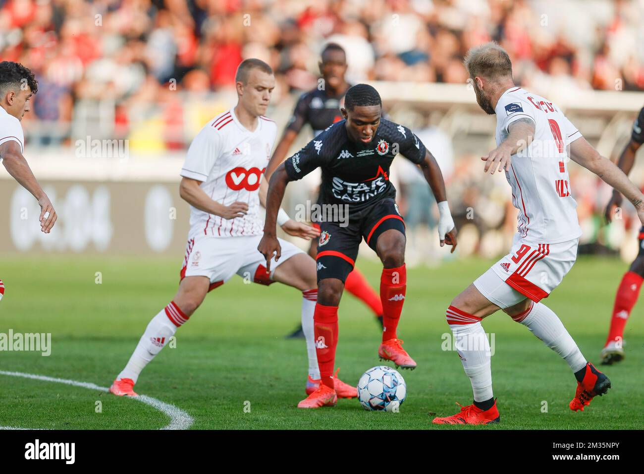 Standard's Hugo Siquet, Seraing's Gerald Kilota and Standard's Joao ...