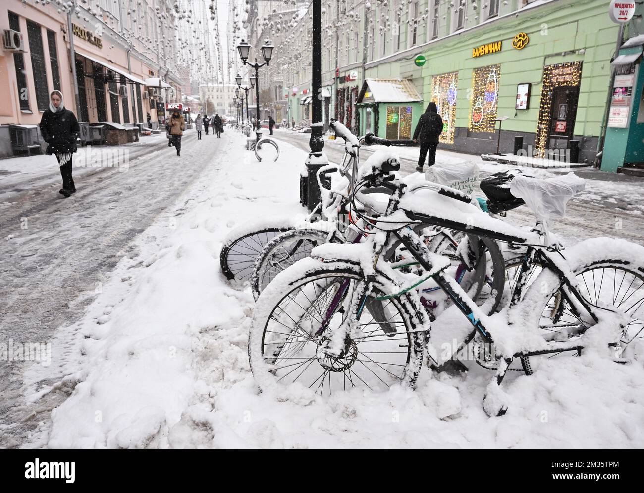 Views of Moscow. Genre photography. Snowfall in the city. Bicycles in ...
