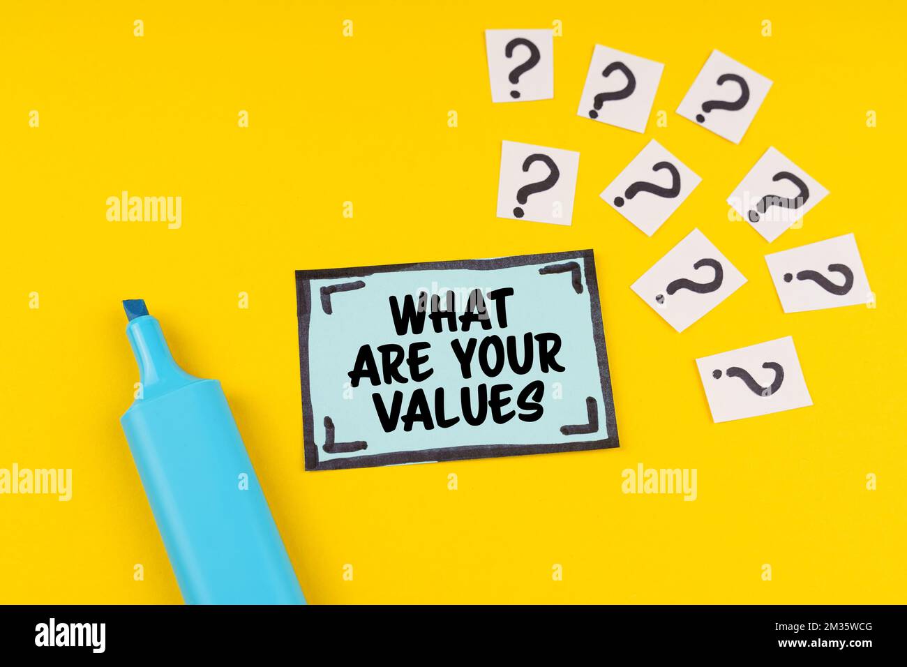 Business concept. On the yellow surface lies a blue marker, question ...