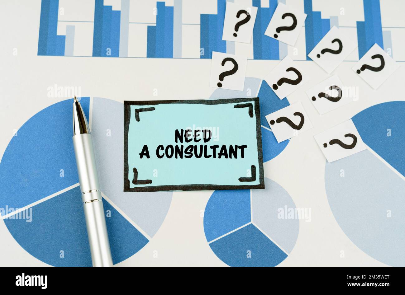 business question concept. On the blue diagrams lies a pen, questions ...