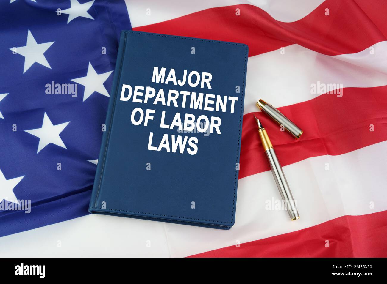 Law concept. On the US flag lies a pen and a book with the inscription ...