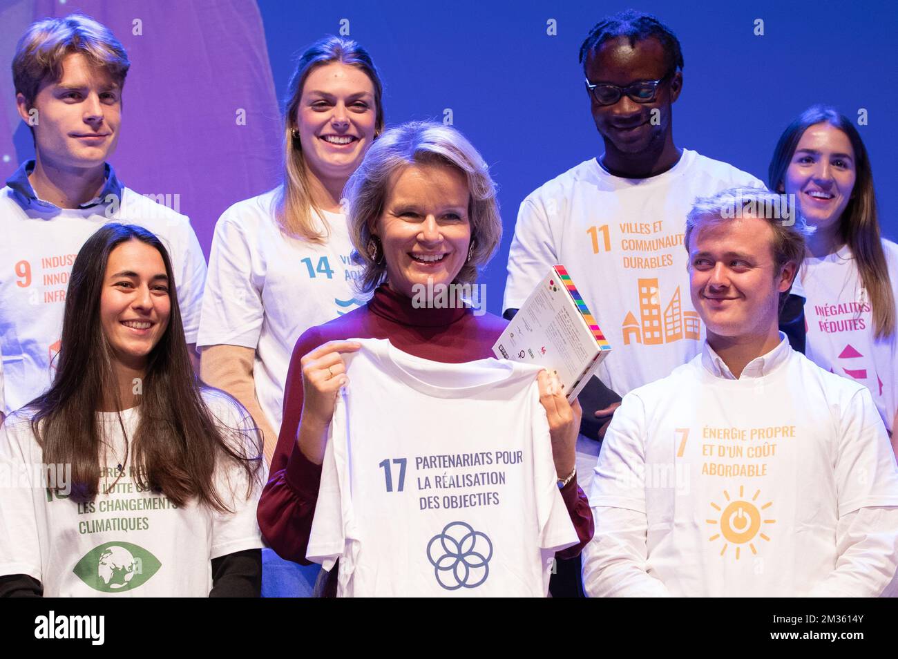 Queen Mathilde of Belgium receives a t-shirt as she poses for the ...