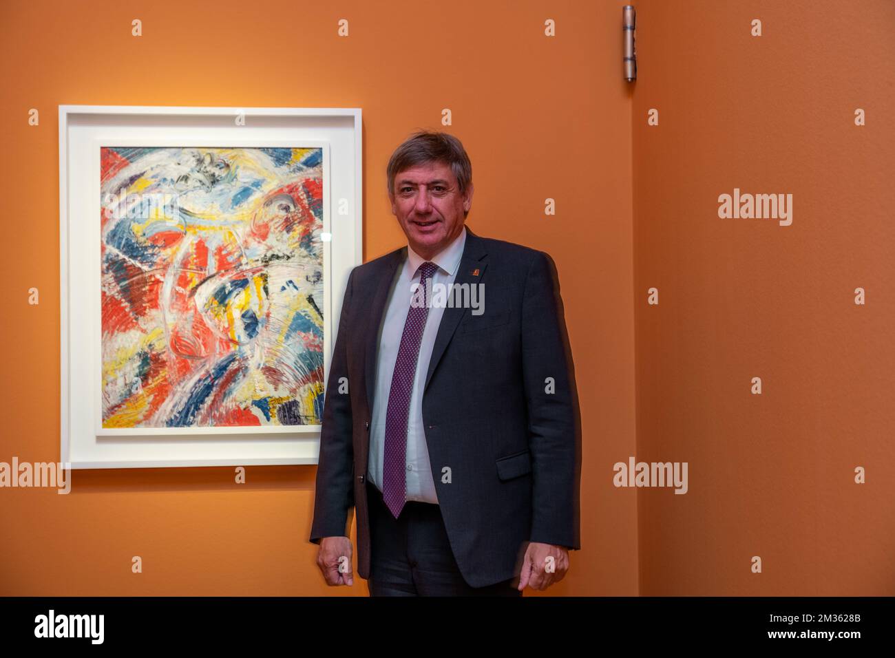 Flemish Minister President Jan Jambon poses with painting 'Ontwikkeling ...