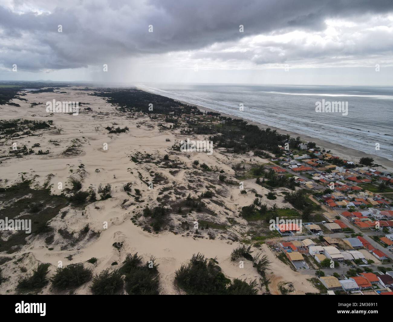 An aerial shot of a sandy beach arena under a cloudy sky in Jaguaruna ...