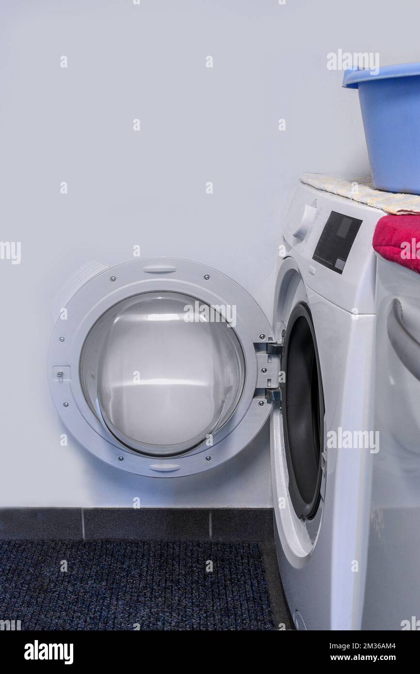 household washing machine corner installation against the wall Stock ...