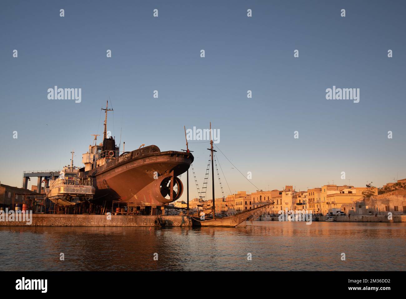 In the port of Mazara del Vallo there is an unfinished metal ship in a ...