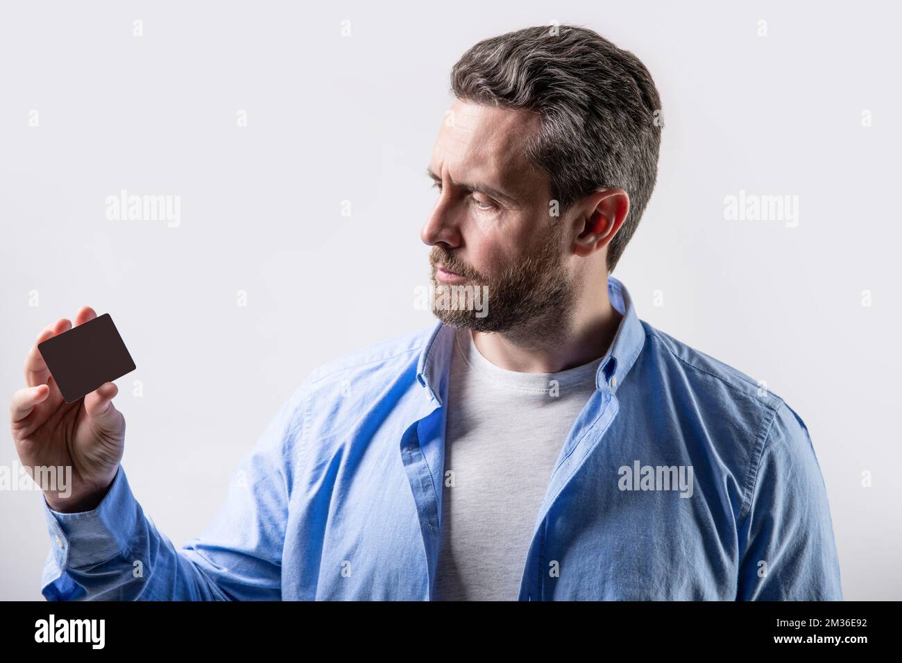 photo of guy look at business card. guy show business card isolated on ...