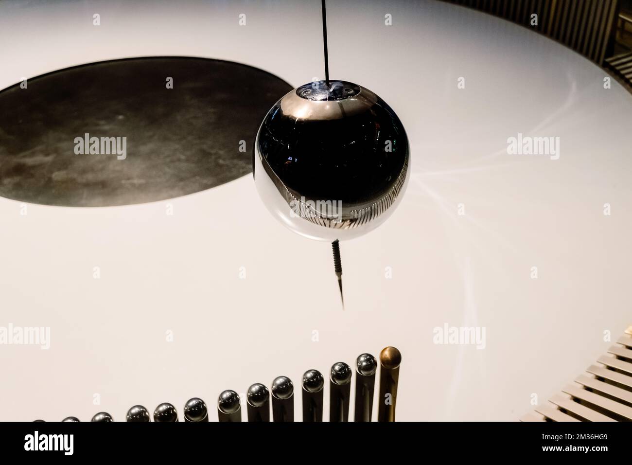 Swinging ball of the Eddy pendulum in a science demonstration Stock ...