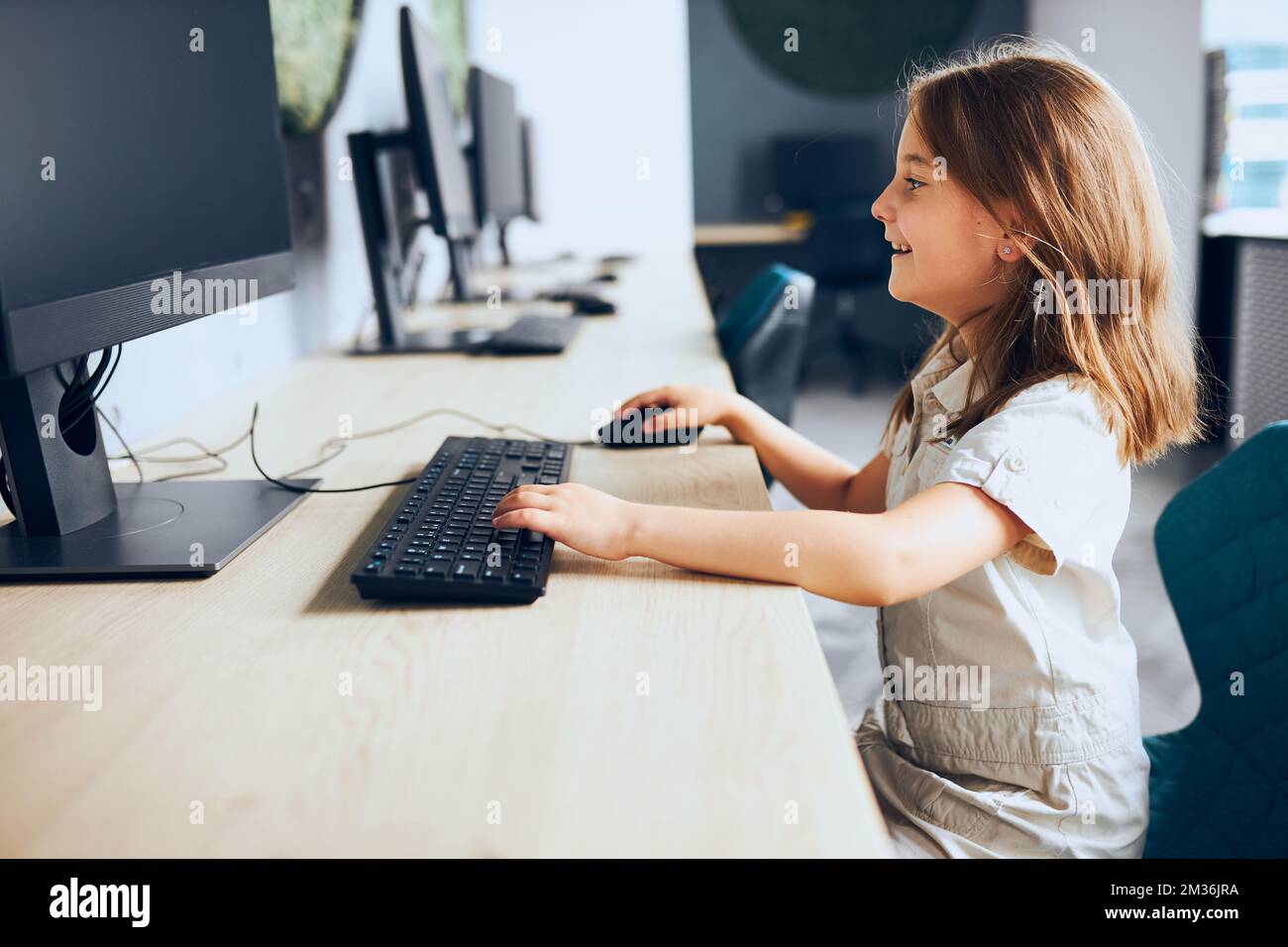 Fascinating computer class. Child learning to use technology in ...