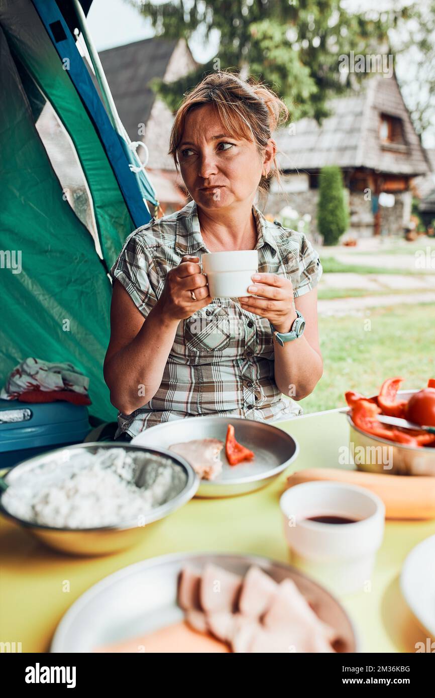 Family having breakfast outdoors on camping during summer vacation ...