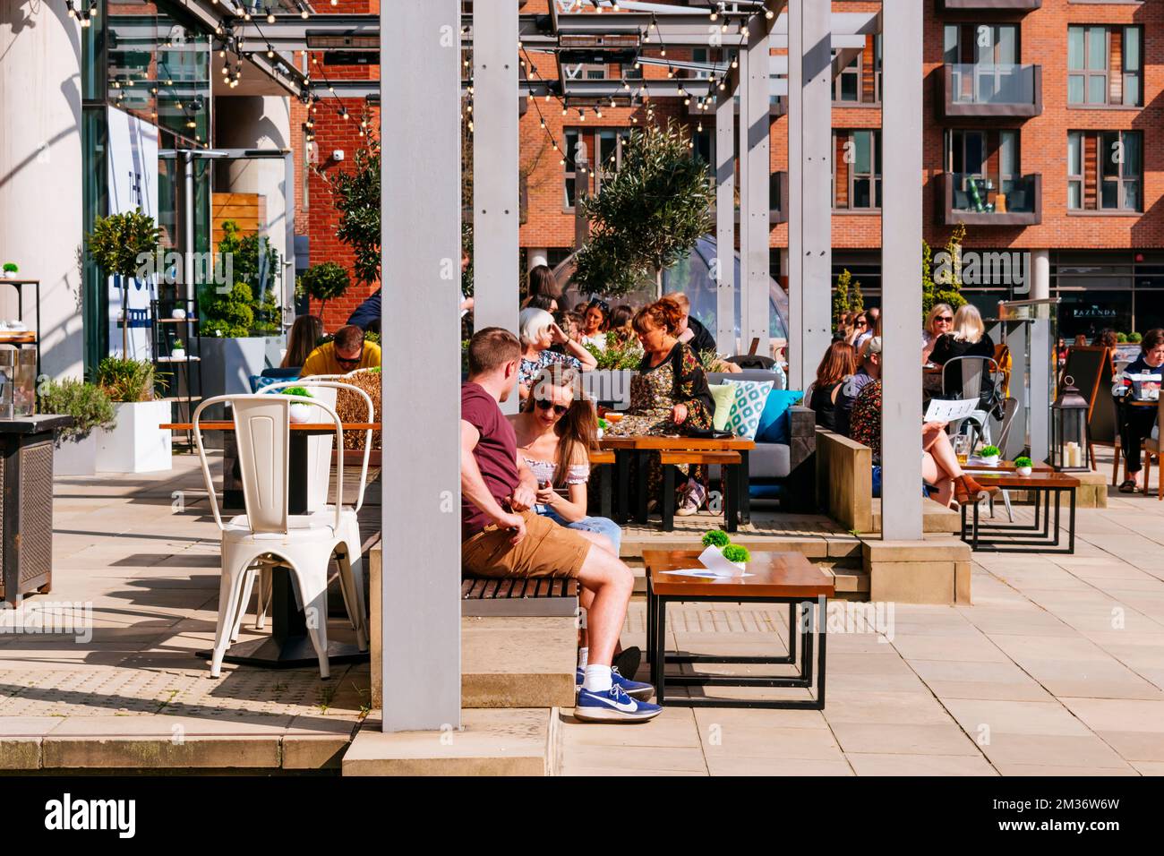 People siting on terrace. Waterman's Place. Granary Wharf is a mixed ...