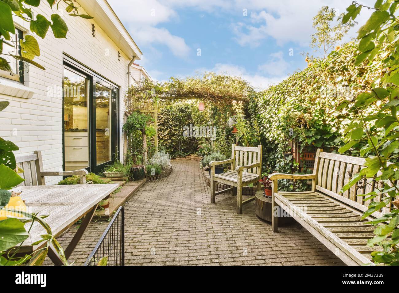 an outside area with benches and plants on the side of the street in ...