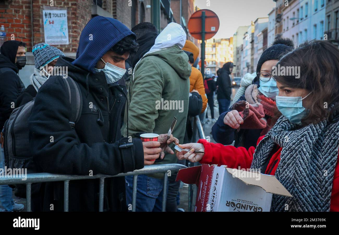 Illustration shows refugees waiting outside, in the cold, at the entry ...