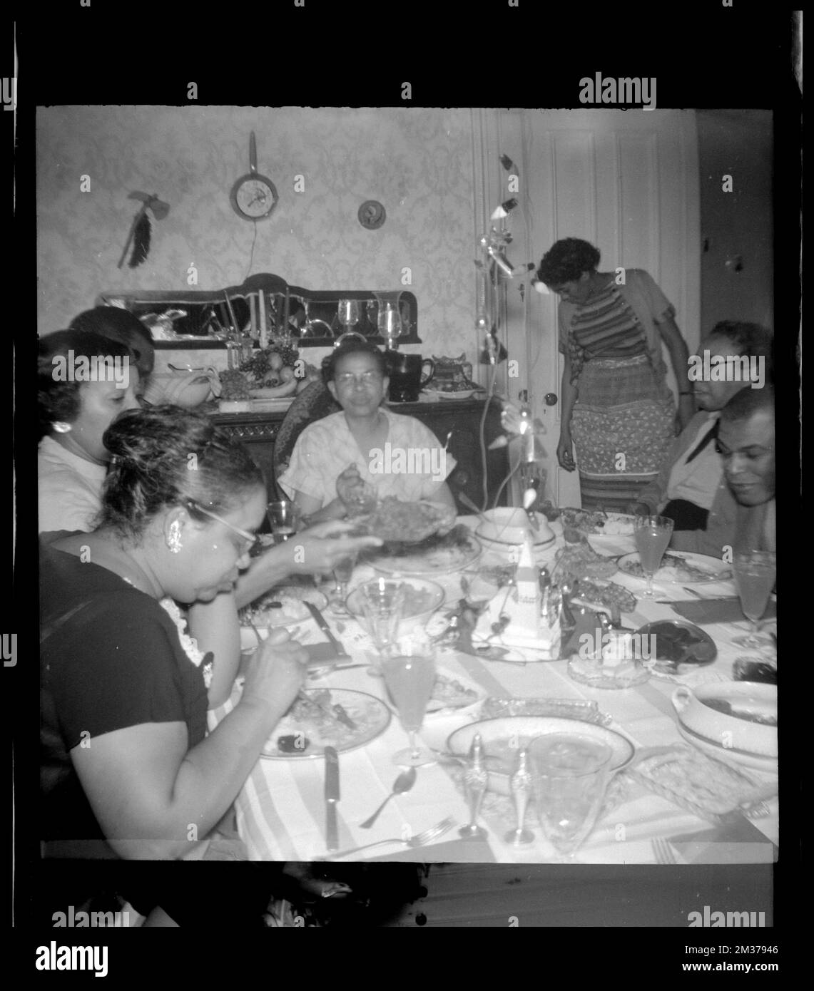 A group of people are seated eating at a dining table, including Lottie ...
