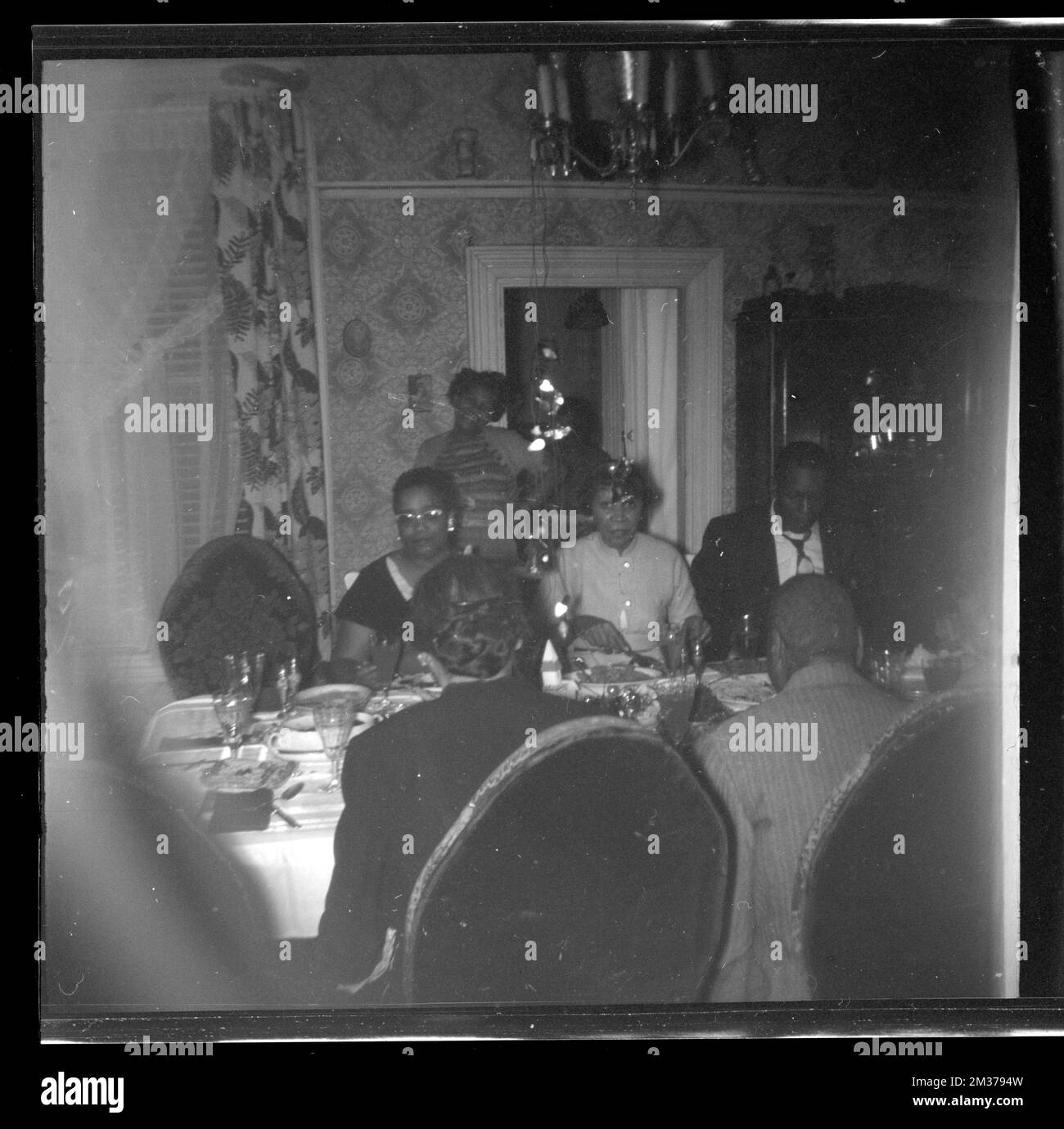 A group of people are seated at a dining table ,. Jack Miller ...