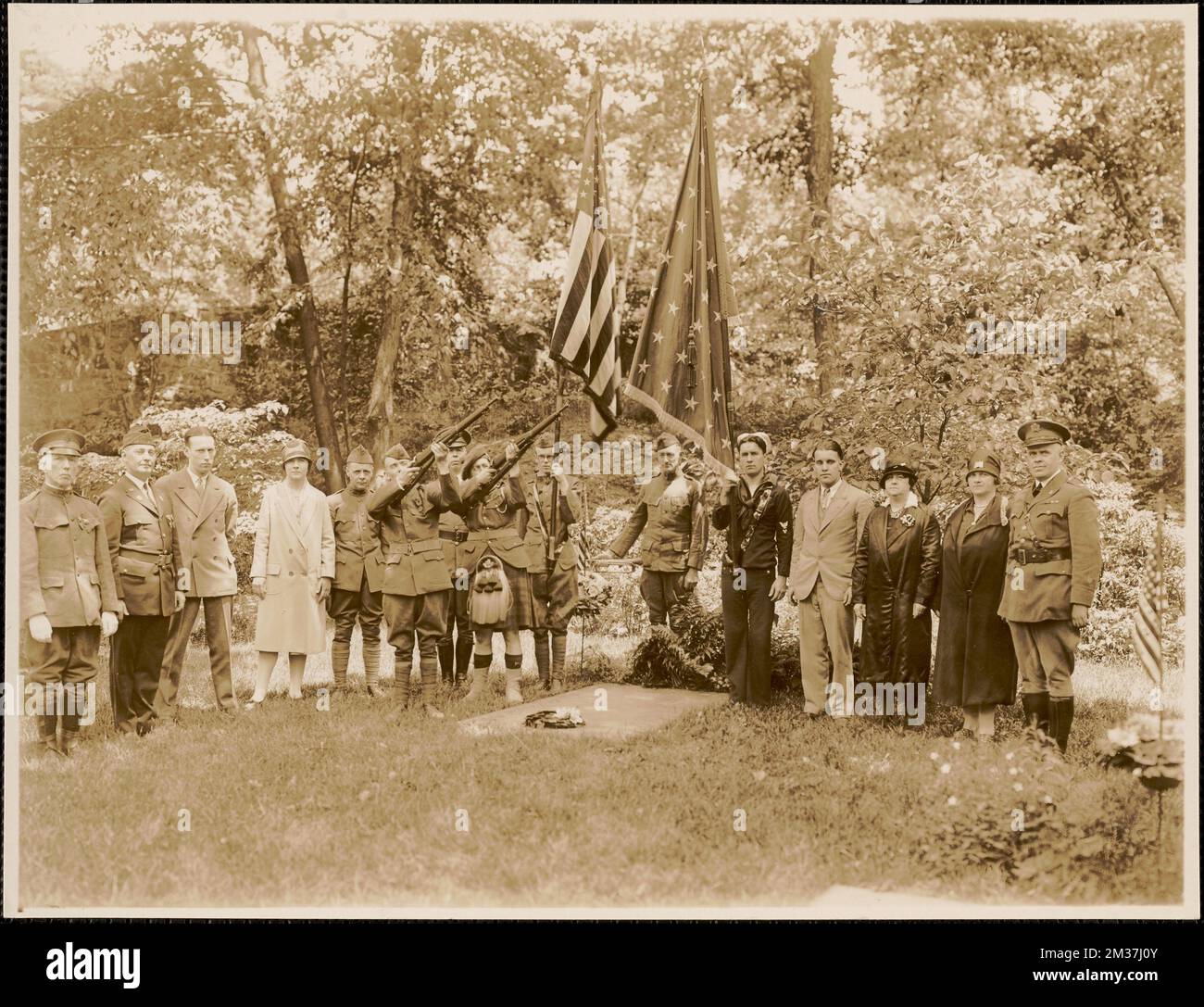 Gun salute with military and civilian attendees flanking laid wreath ...