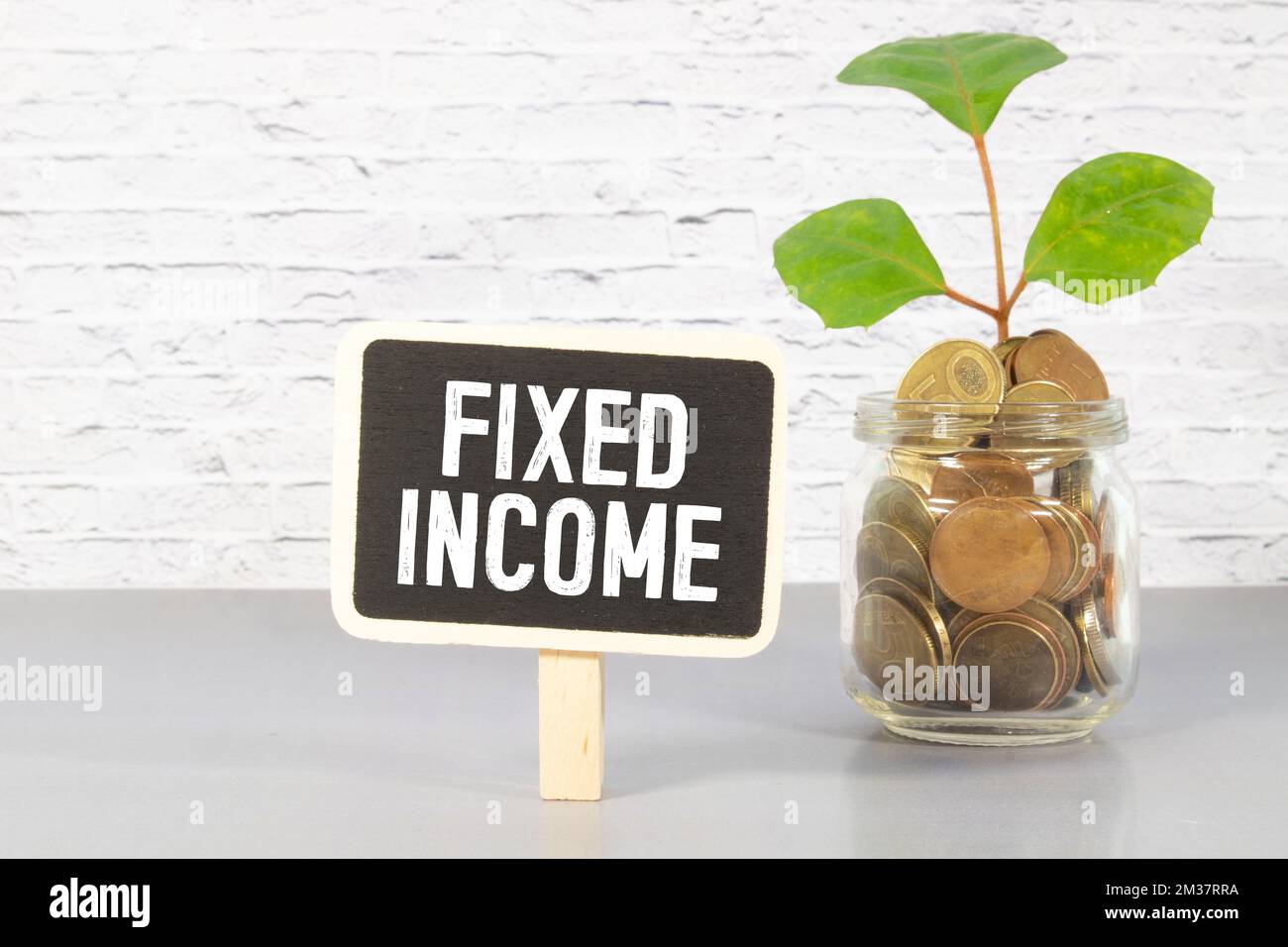 FIXED INCOME text on sticker on calculator with pen,pencil on white ...