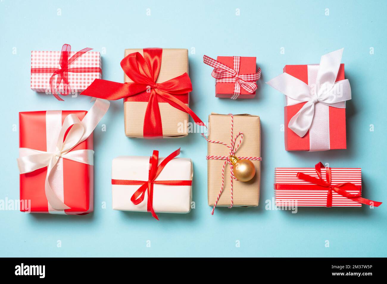 Christmas presents on blue background top view Stock Photo - Alamy
