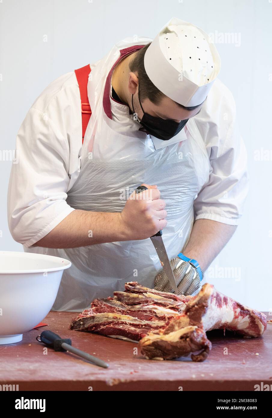 Illustration shows someone learning to be a butcher, cutting meat ...