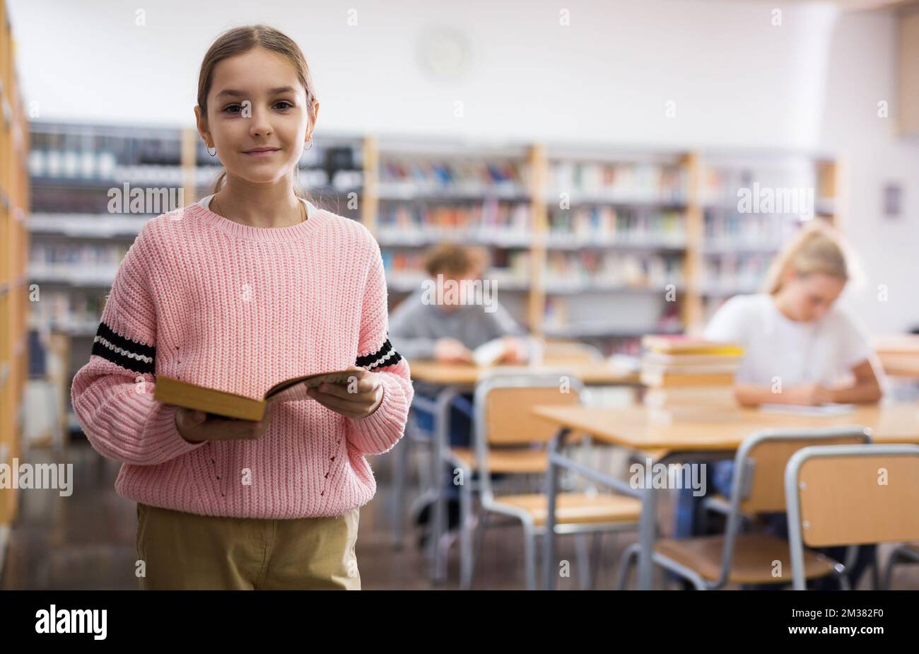 Portrait of a ten-year-old schoolgirl with a book Stock Photo - Alamy