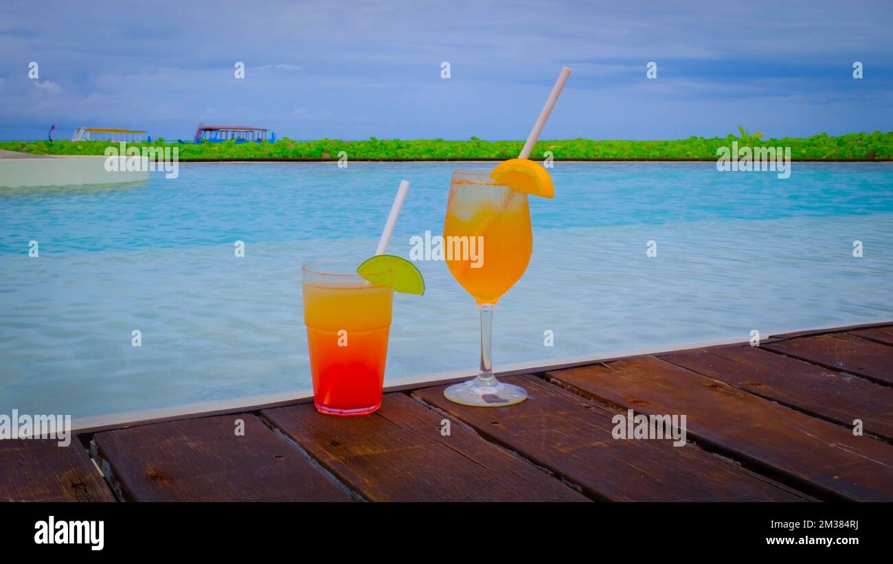 Close up of cocktails with a swimming pool. Two drinks is standing ...