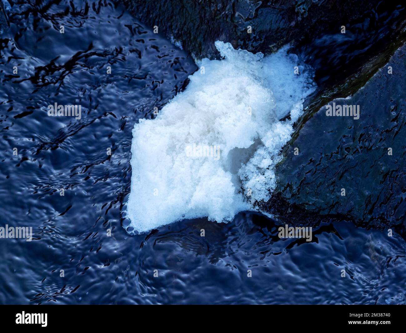 Foam on a stream, frozen in winter below Esk Pike,, Langdale, Lake ...