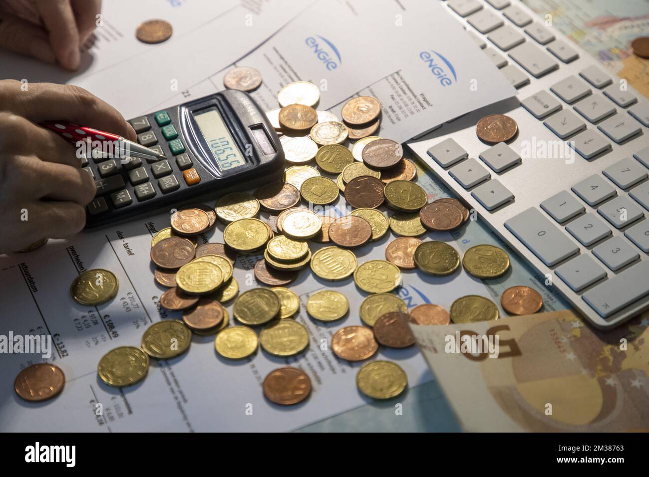 Illustration picture shows a calculator and euro coins, lying on an ...