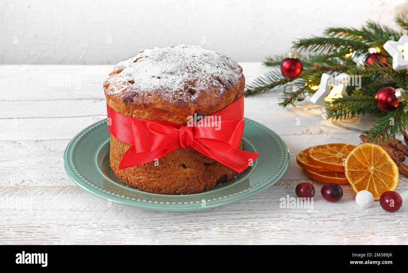 Homemade Panettone on light background with dried oranges and brunches ...